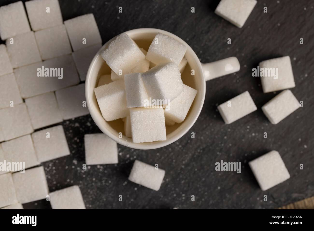 white square sugar on a black background , lump sugar in the shape of a ...
