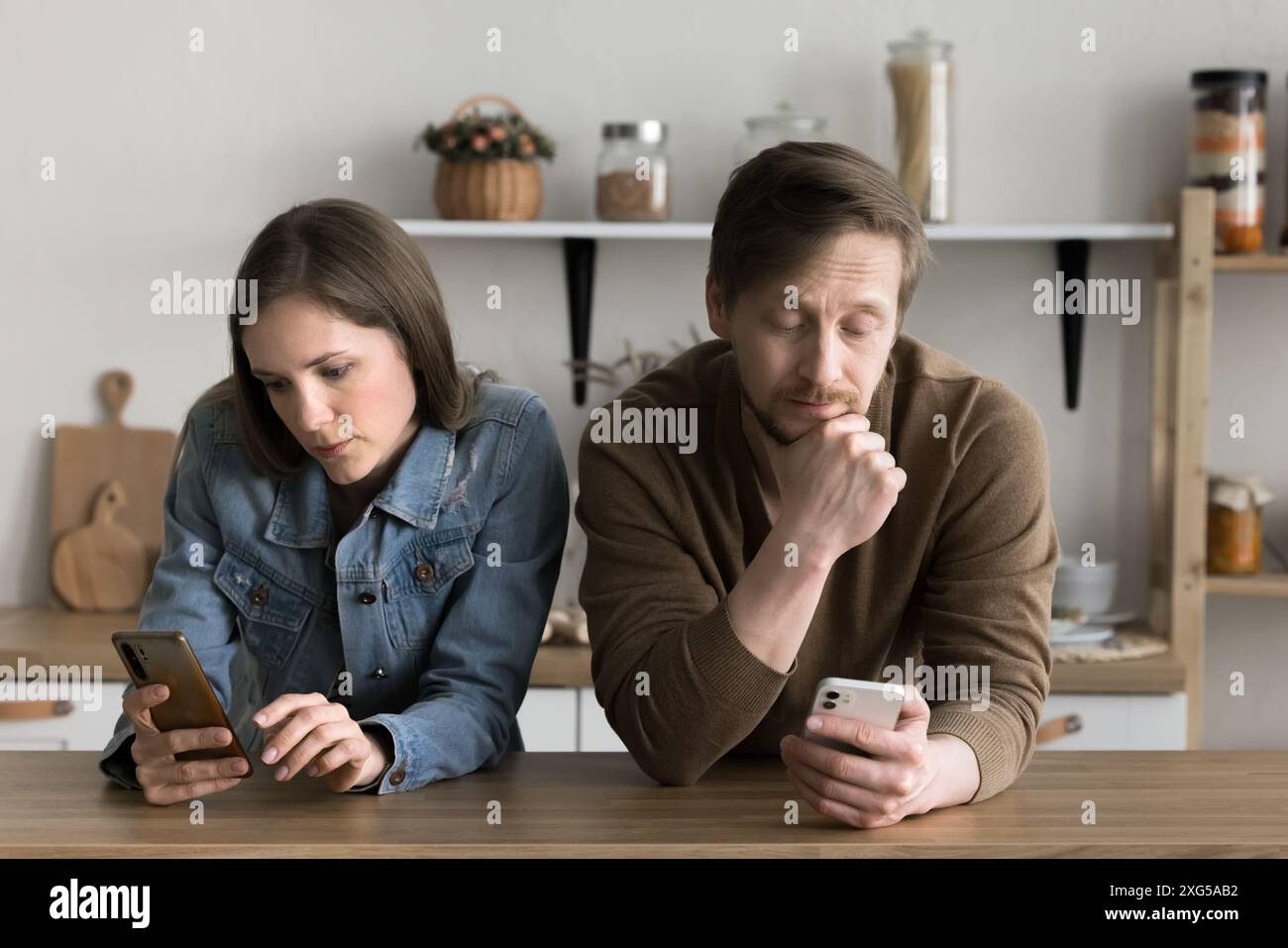 Couple ignoring other using mobile hi-res stock photography and images ...