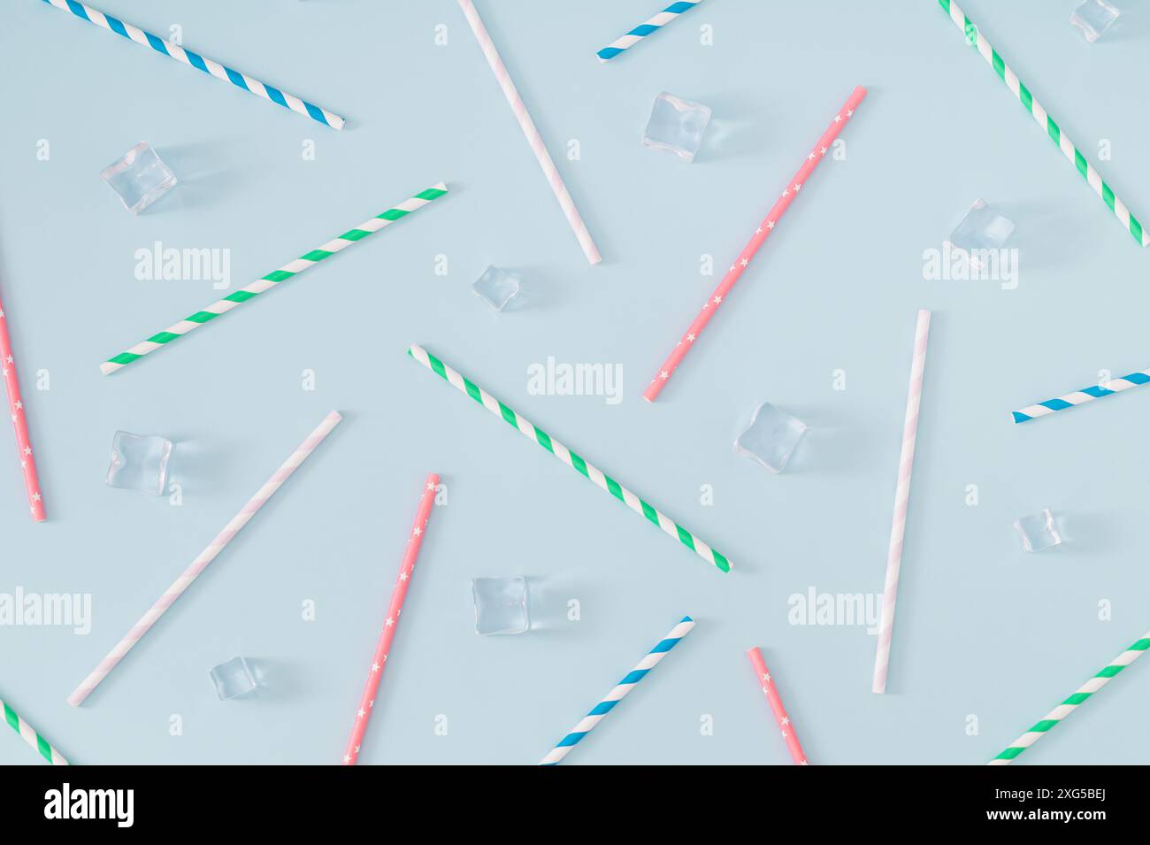 Trendy pattern made with ice cubes and various colorful paper drinking ...