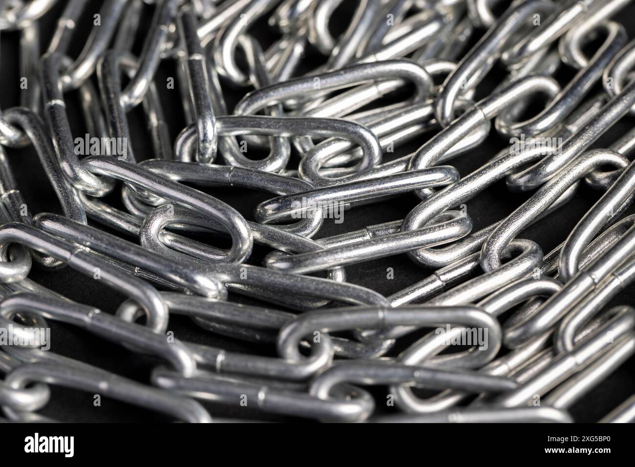 silver steel chain on a black background, steel chain links connected ...
