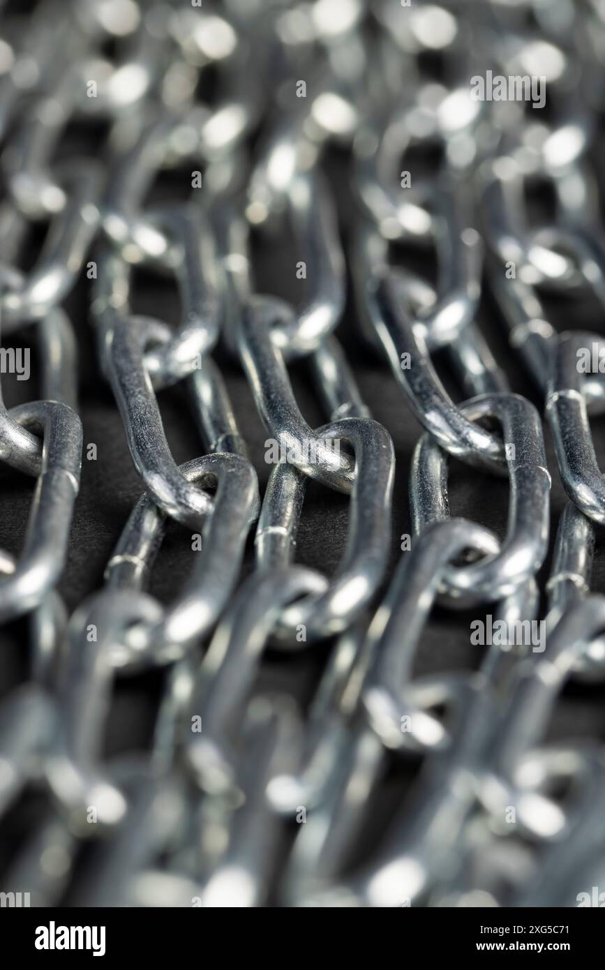 silver steel chain on a black background, steel chain links connected ...