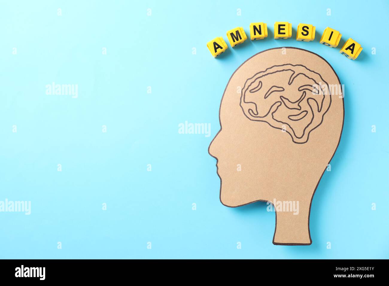 Yellow cubes with word Amnesia and human head cutout with drawing of ...