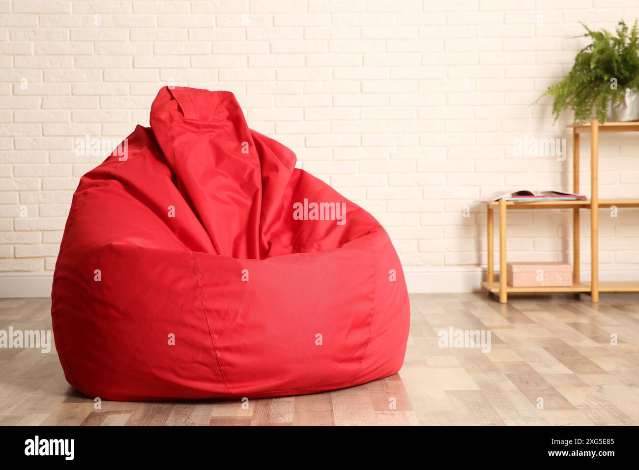 Red bean bag chair on floor in room Stock Photo - Alamy