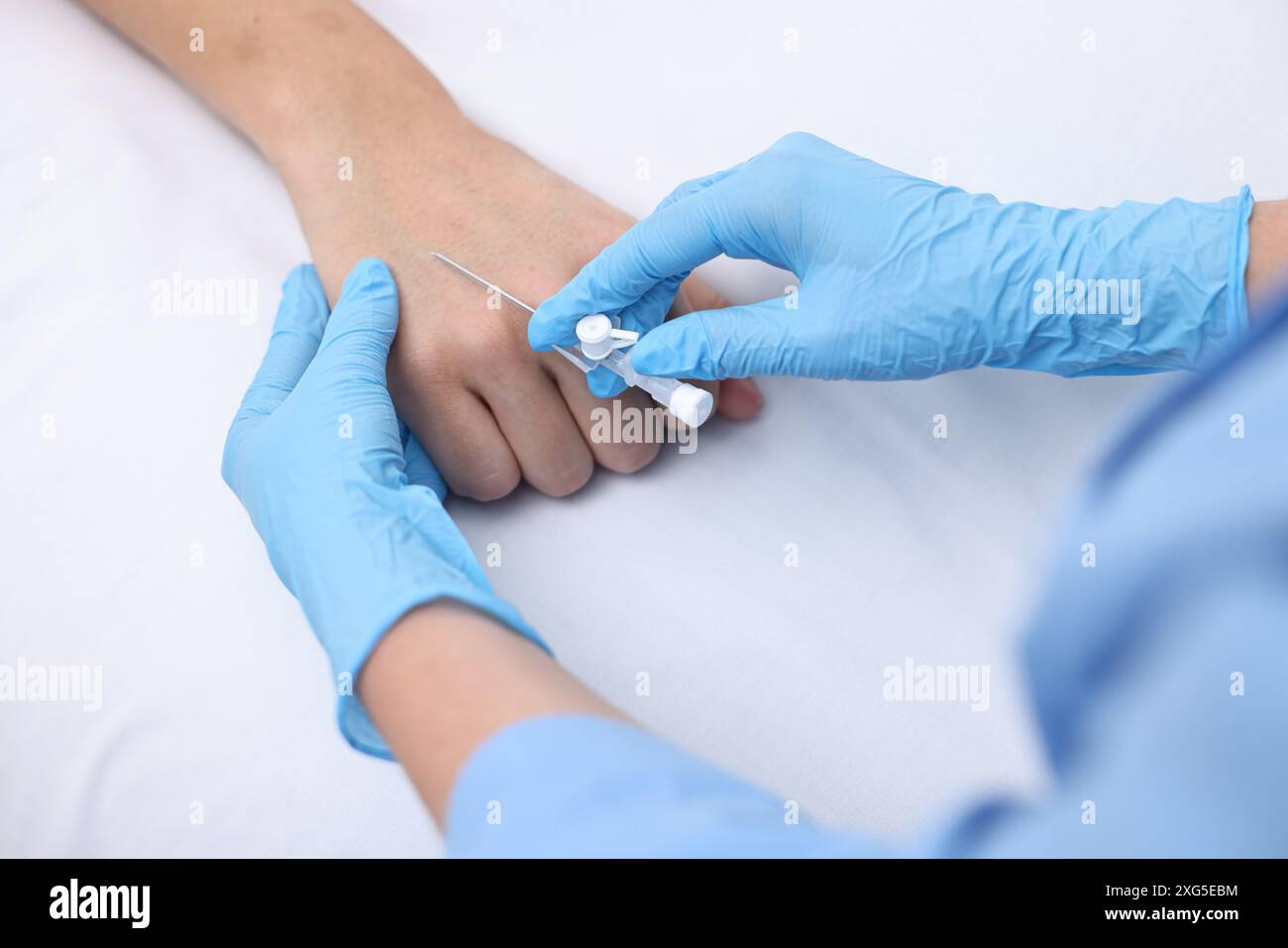 Nurse inputting catheter for IV drip in patient hand, closeup Stock ...