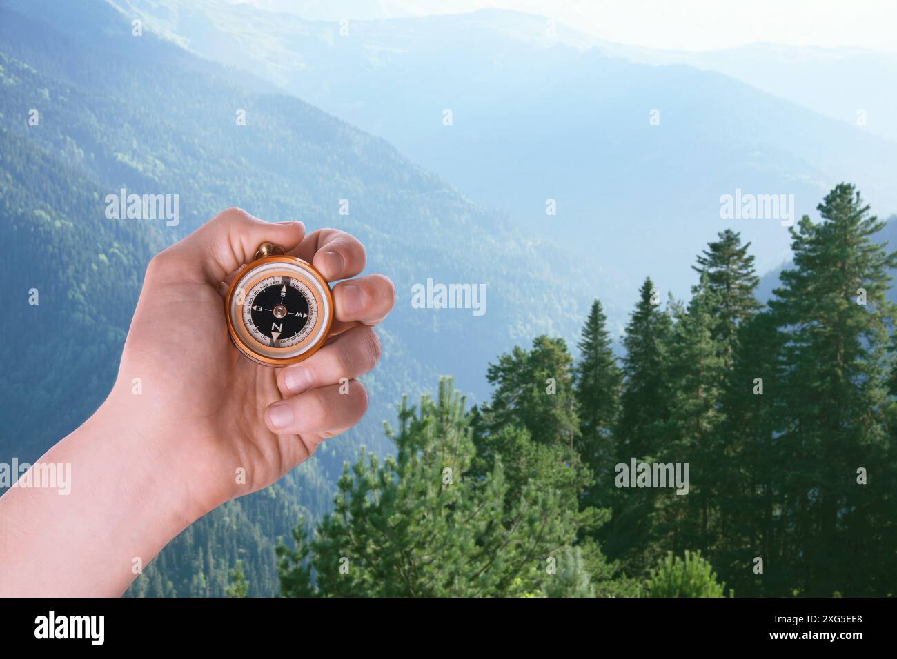 Man using compass in mountains, closeup. Navigational instrument Stock ...