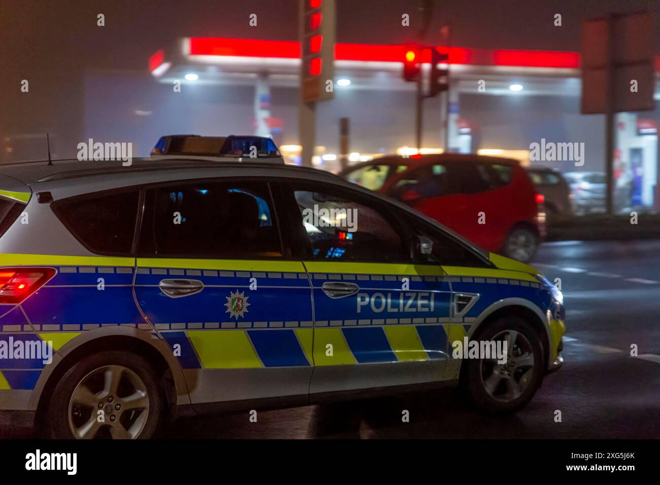Police car passes a petrol station Stock Photo - Alamy