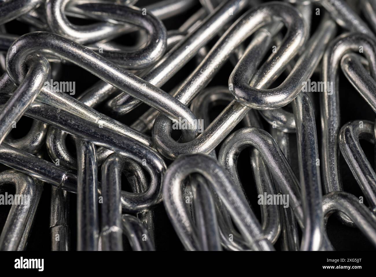 silver steel chain on a black background, steel chain links connected ...