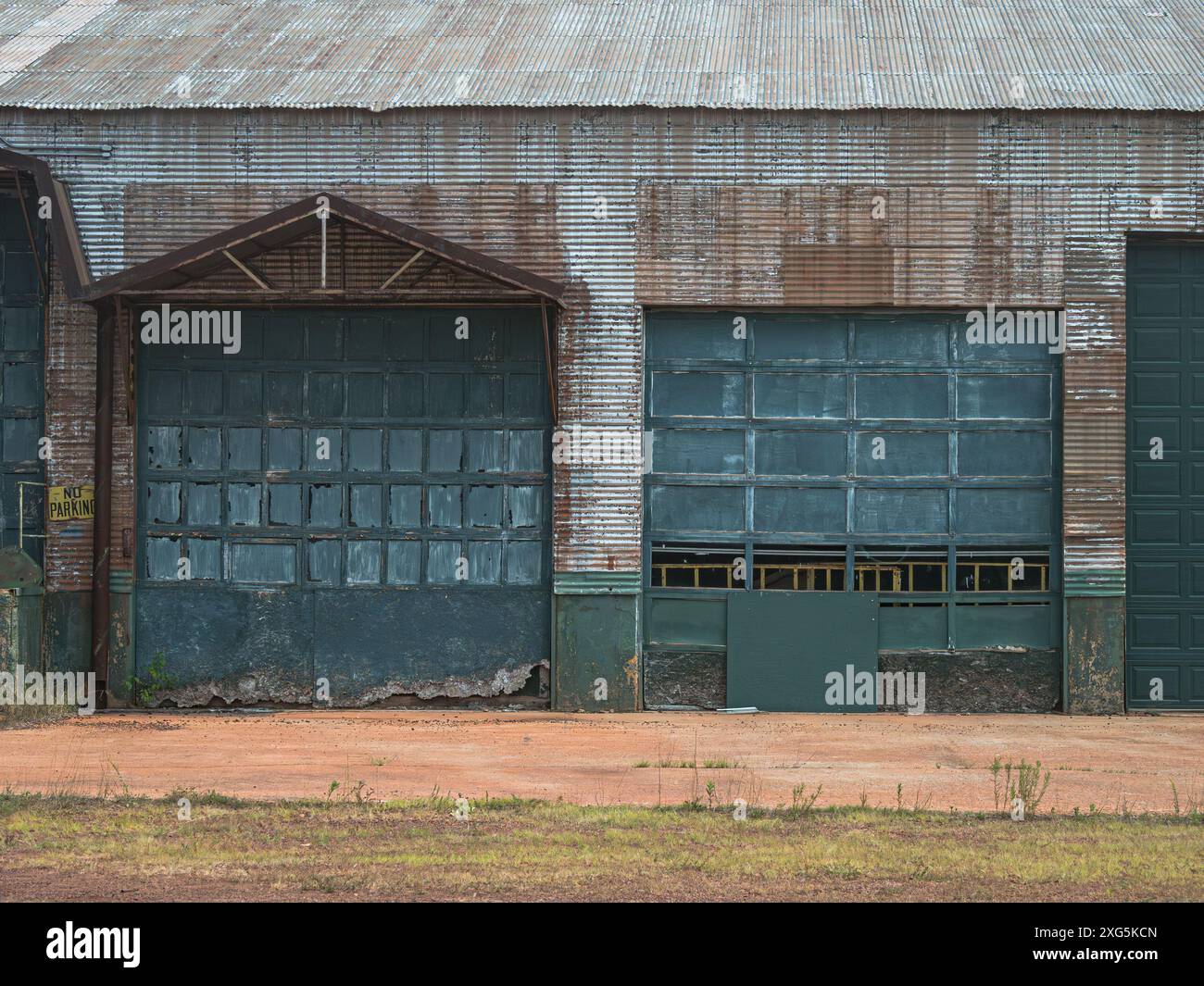Old wood garage doors in a run-down steel building Stock Photo - Alamy
