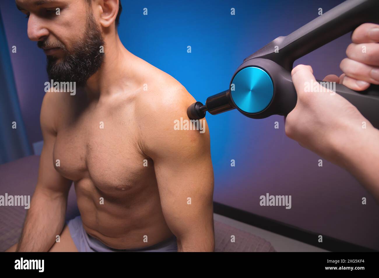Bearded Caucasian Man Getting Percussion Shoulder Massage By A Massager In A Professional