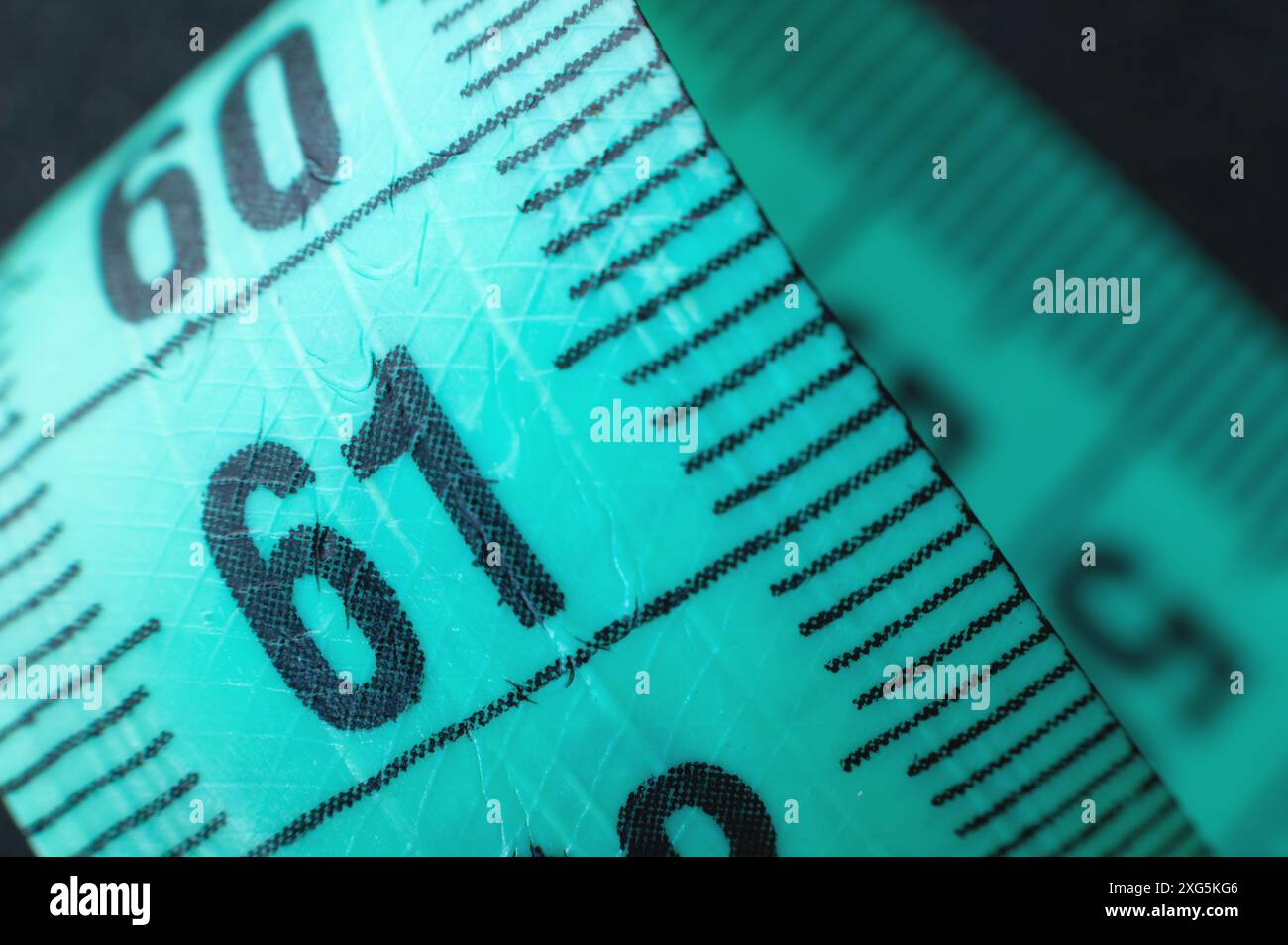 Close-up of rolled up tape measure on number 61. Slim waist and healthy ...