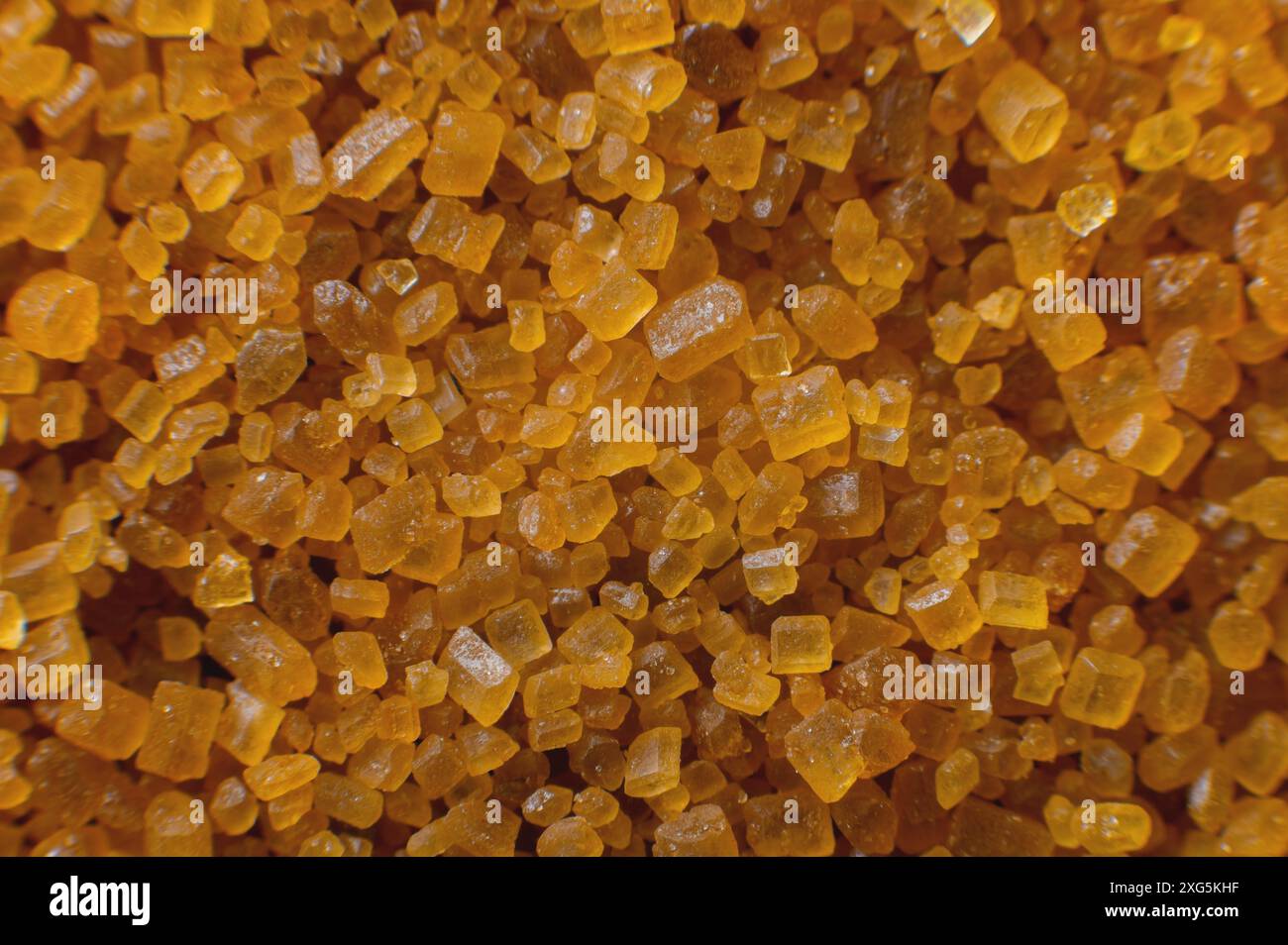 Extreme macro. Sugar crystals. Close-up of brown cane sugar on a plane ...