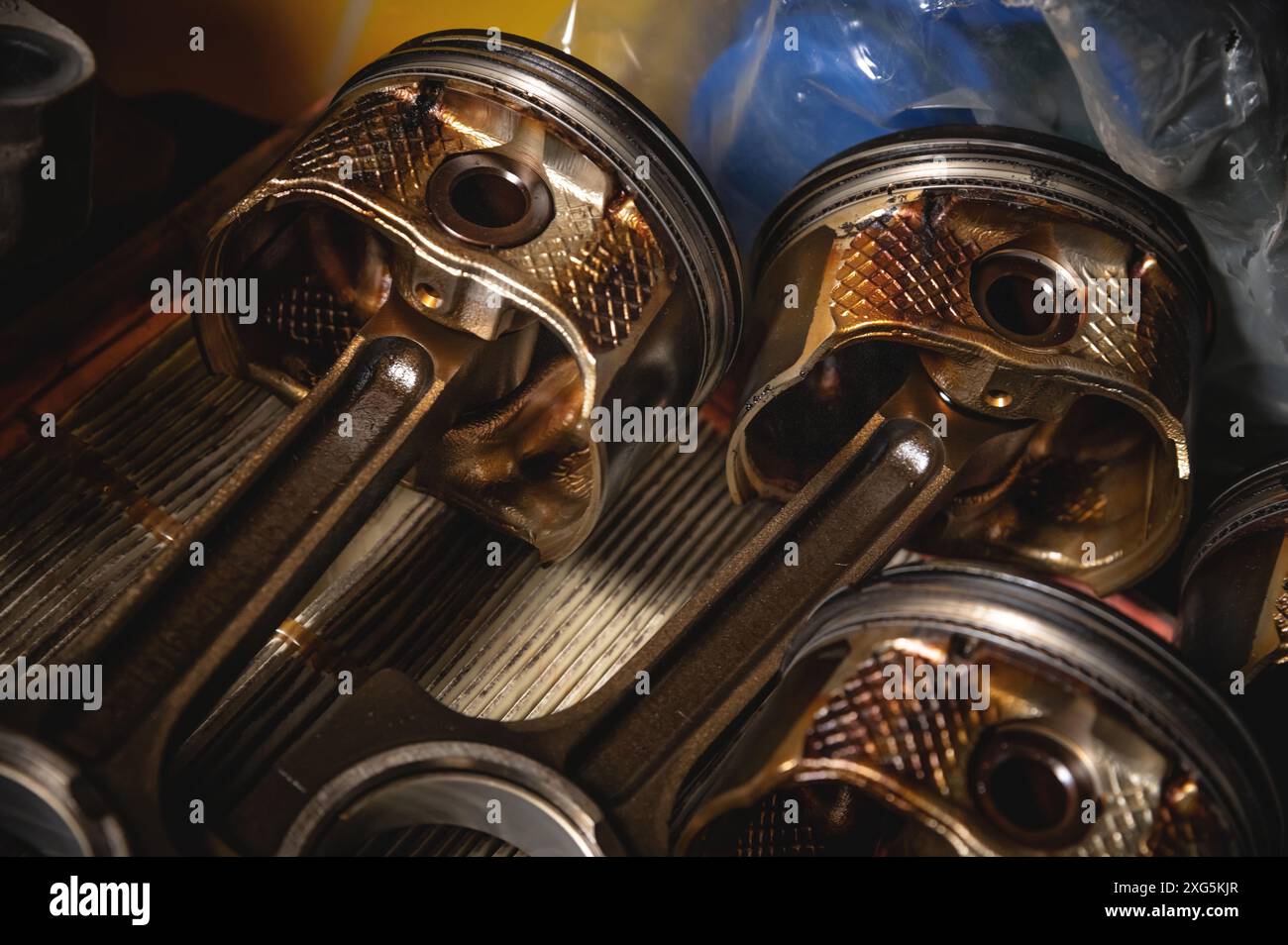 Old used engine pistons close up. Four pistons from an old disassembled ...