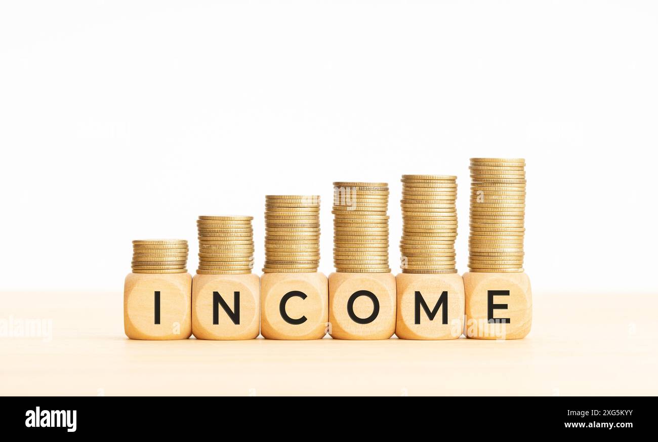 Income concept. Wooden blocks with text and rising stacked coins. Copy ...