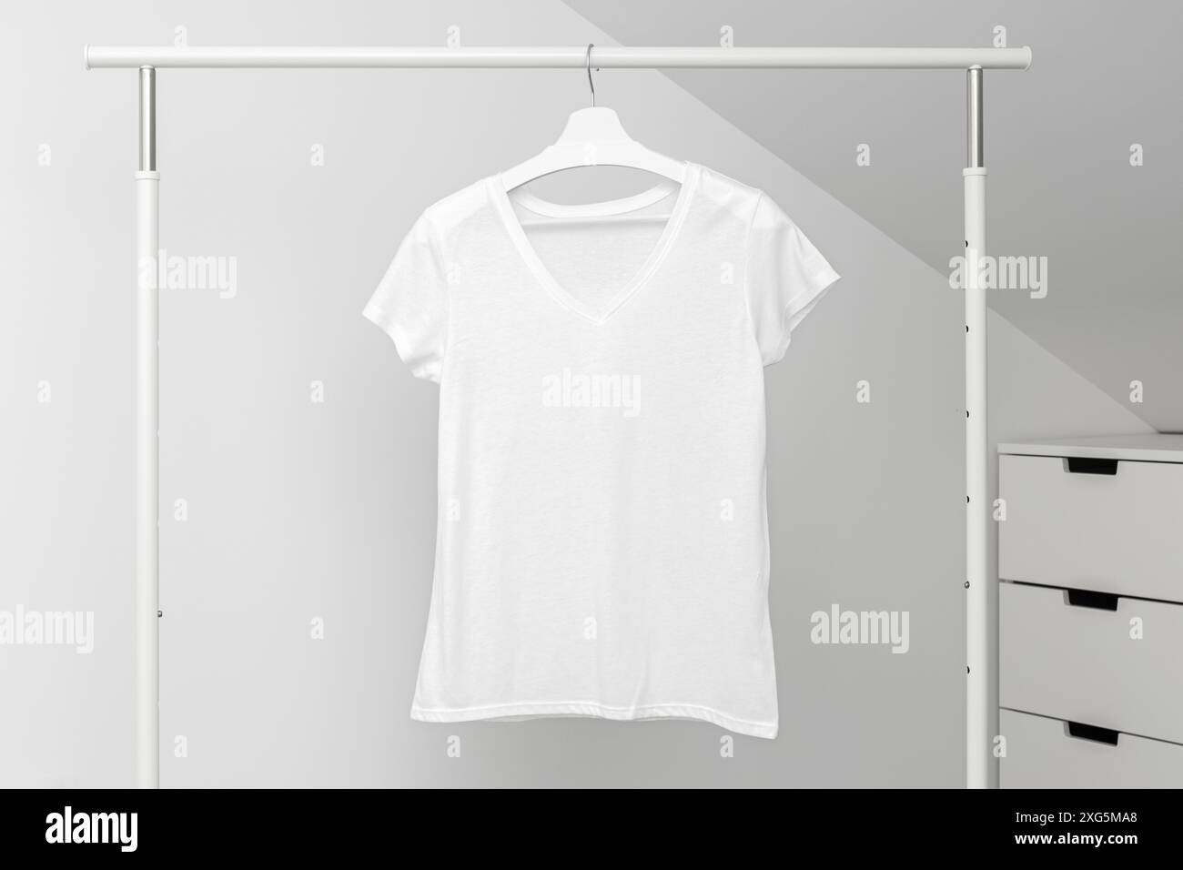 V neck t-shirt hanging on Clothing rack. White color. Template, mock up ...