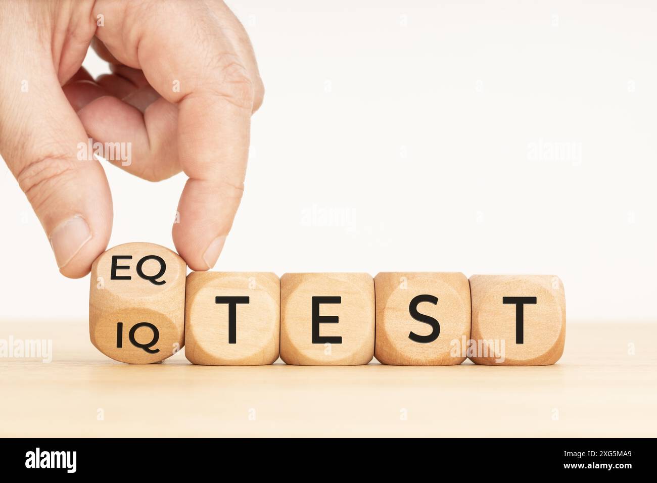 Hand flipping a wooden block with eq test and iq test phase. Copy space ...