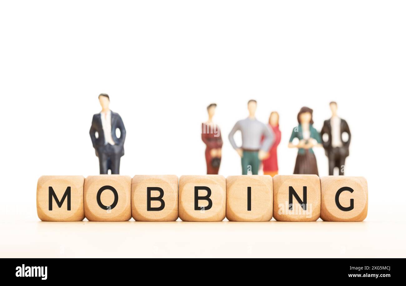 Mobbing concept. Wooden blocks with text and human figurines at ...