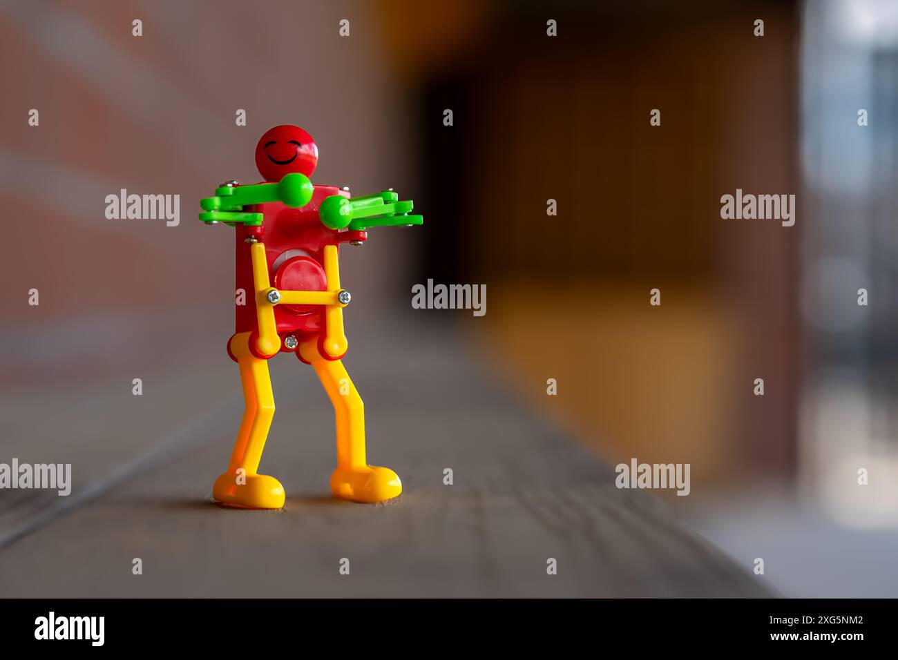 Photo of a funny plastic toy robot doing a happy dance, celebrating, on ...