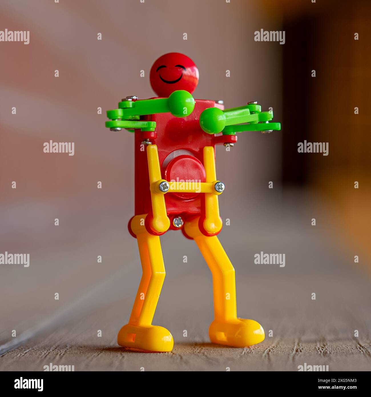Photo of a funny plastic toy robot doing a happy dance, celebrating, on ...