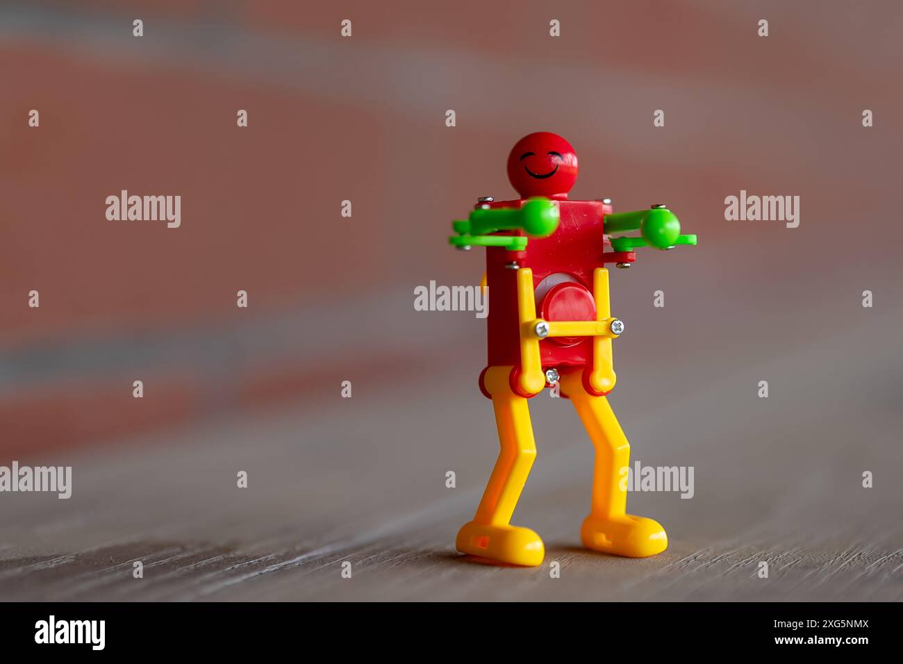 Photo of a funny plastic toy robot doing a happy dance, celebrating, on ...