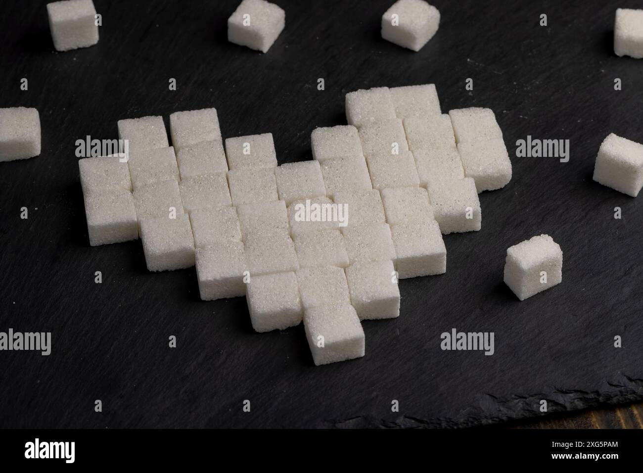 white square sugar on a black background , lump sugar in the shape of a ...