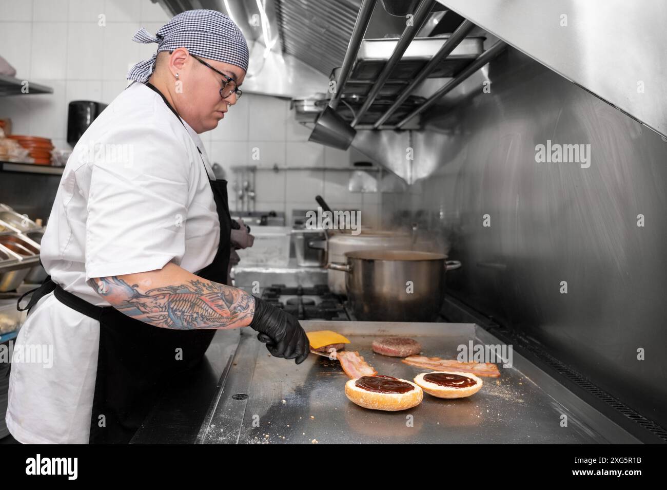 Burger Restaurant. Female Chef Cooking Burgers In Kitchen. High quality ...