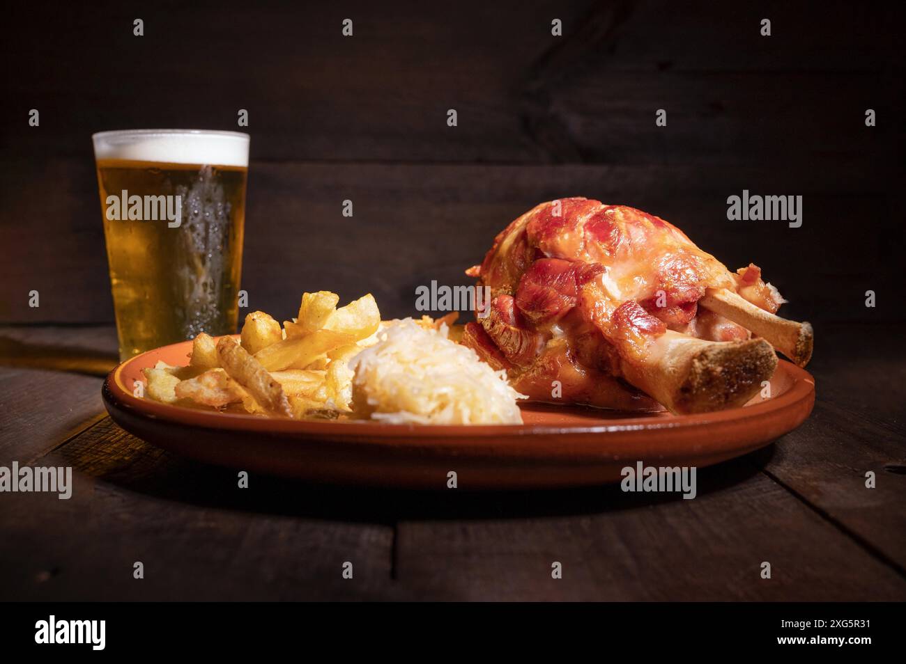 Traditional German cuisine roasted ham hock, sauerkraut and Beer ...