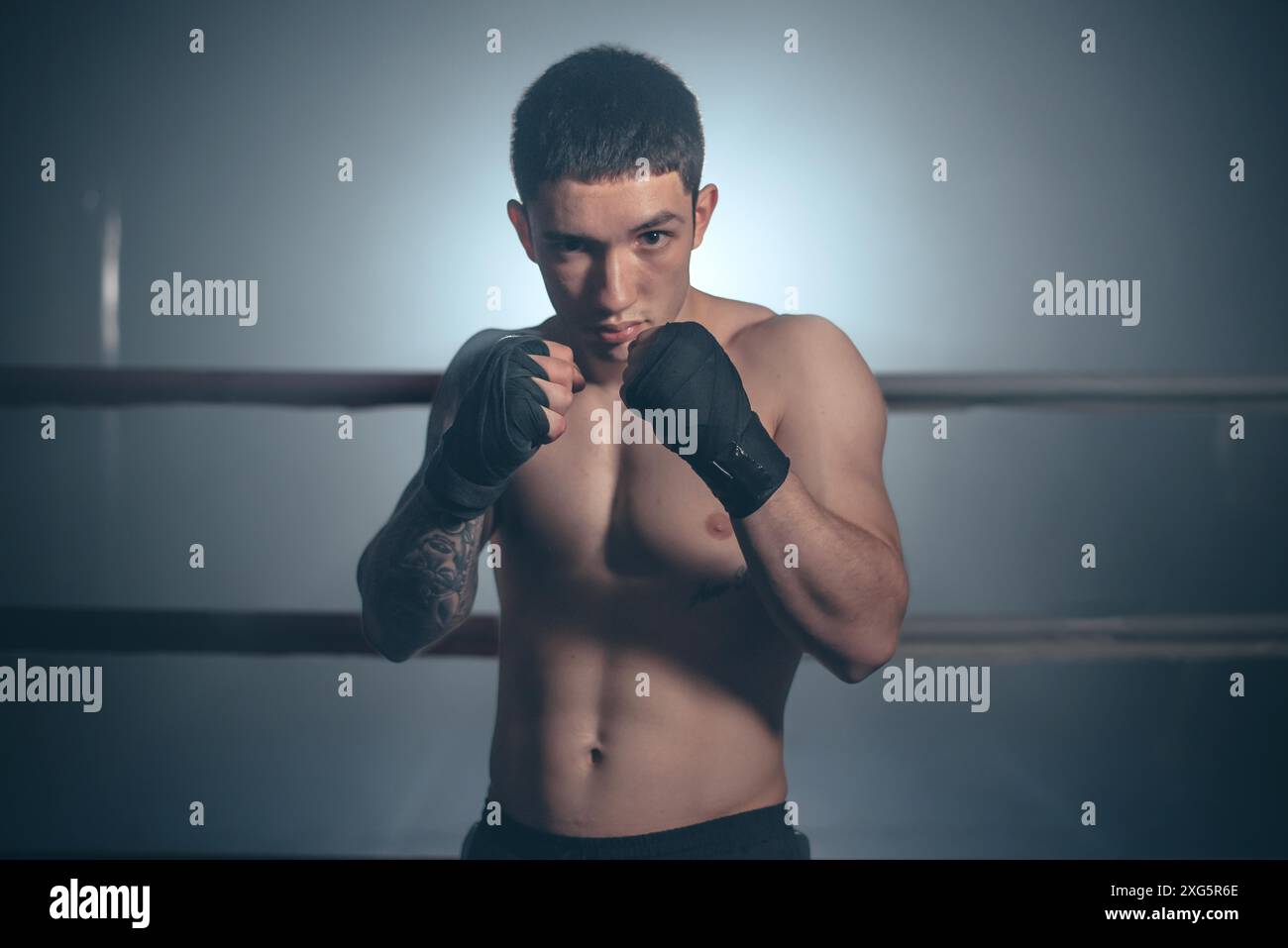 Boxer, man posing in bandage on boxing ring. Fitness and boxing concept. High quality photo ...