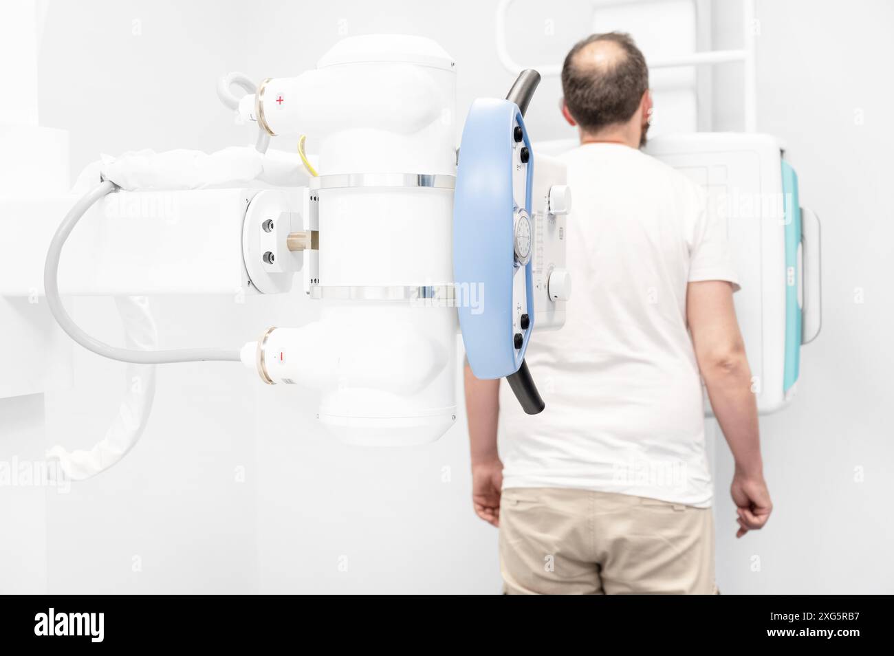 Man in x-ray room having medical scan examination in a modern hospital ...