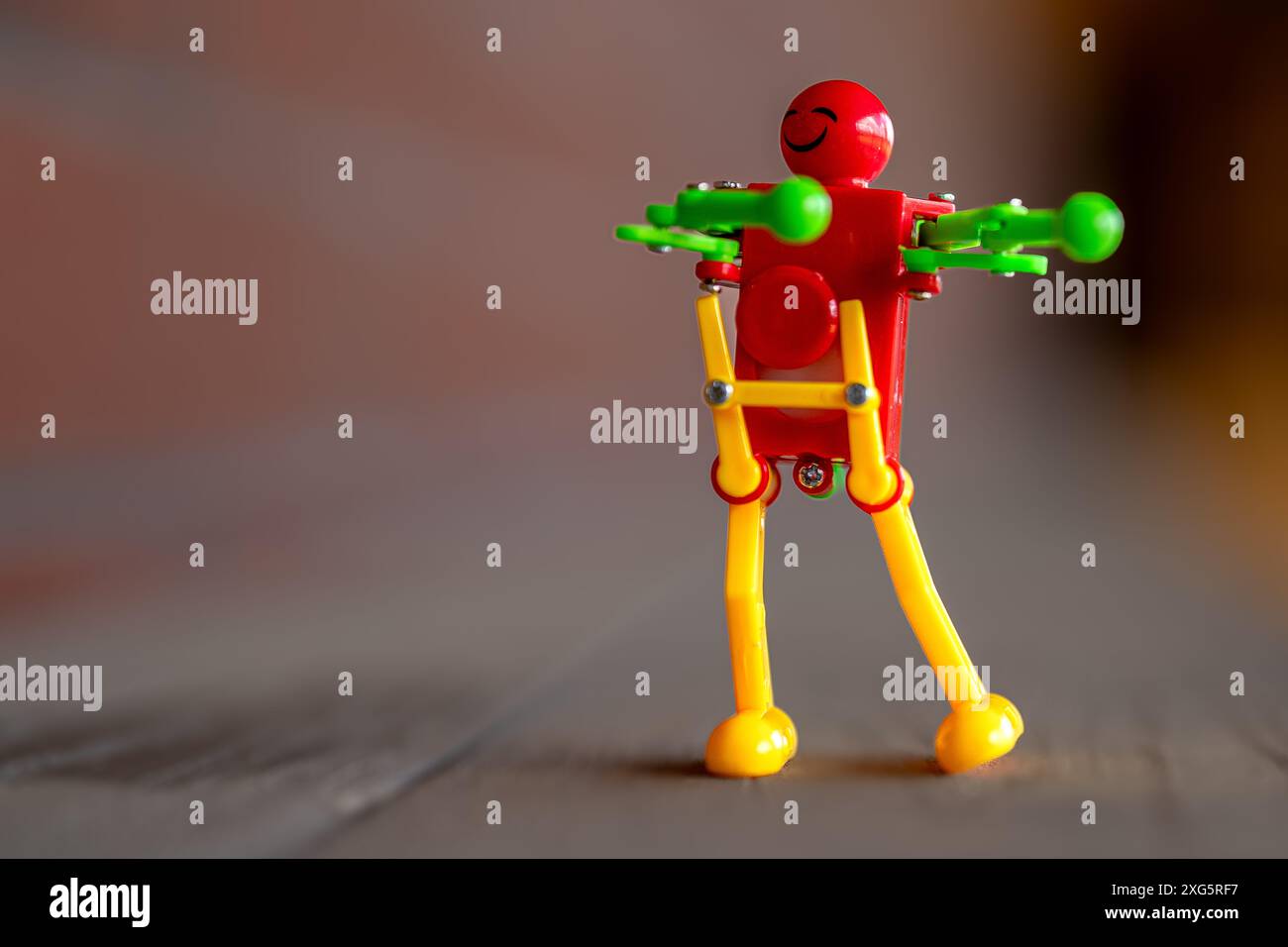Photo of a funny plastic toy robot doing a happy dance, celebrating, on ...