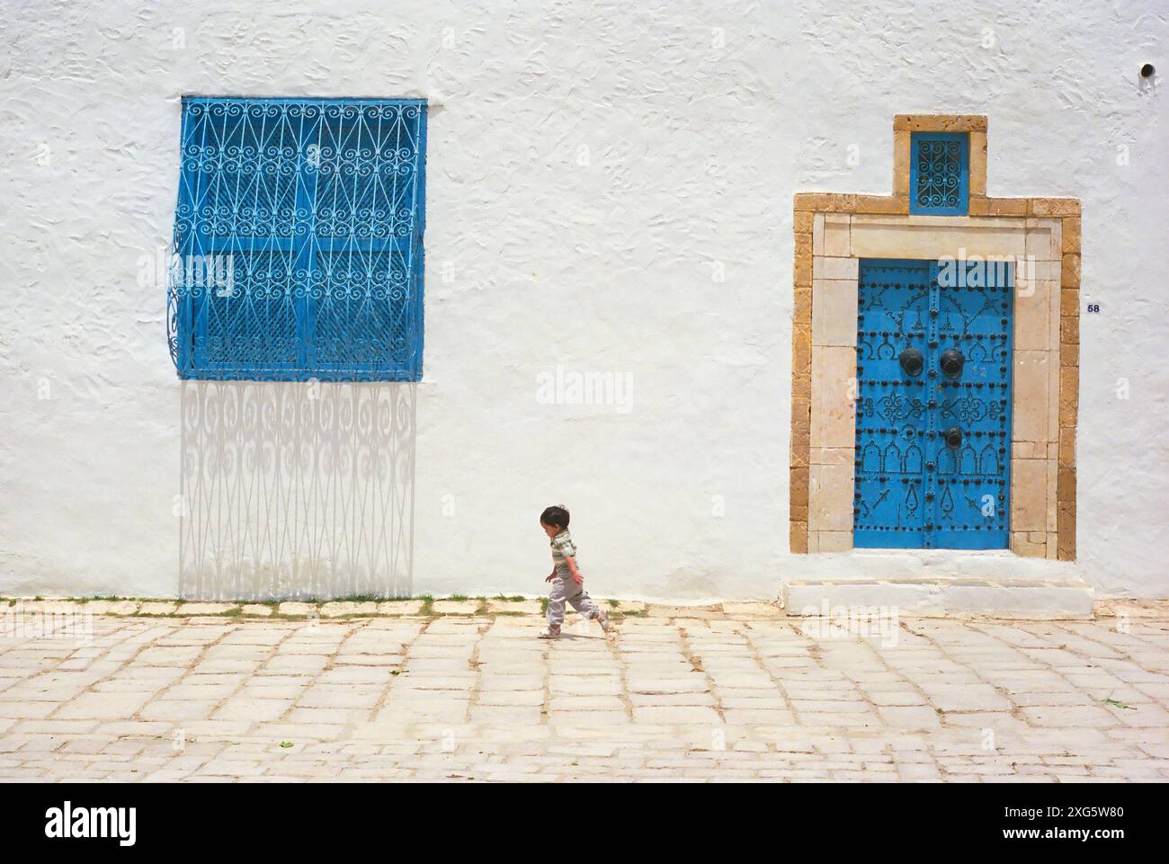Tunisia, Sidi Bou Said. Little Boy Walking in the Street Stock Photo ...