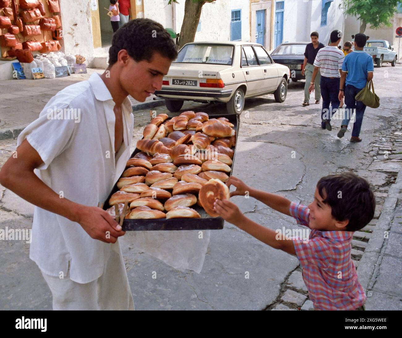 Tunisia, Sidi Bou Said. Boy Buying a Pastry Stock Photo - Alamy