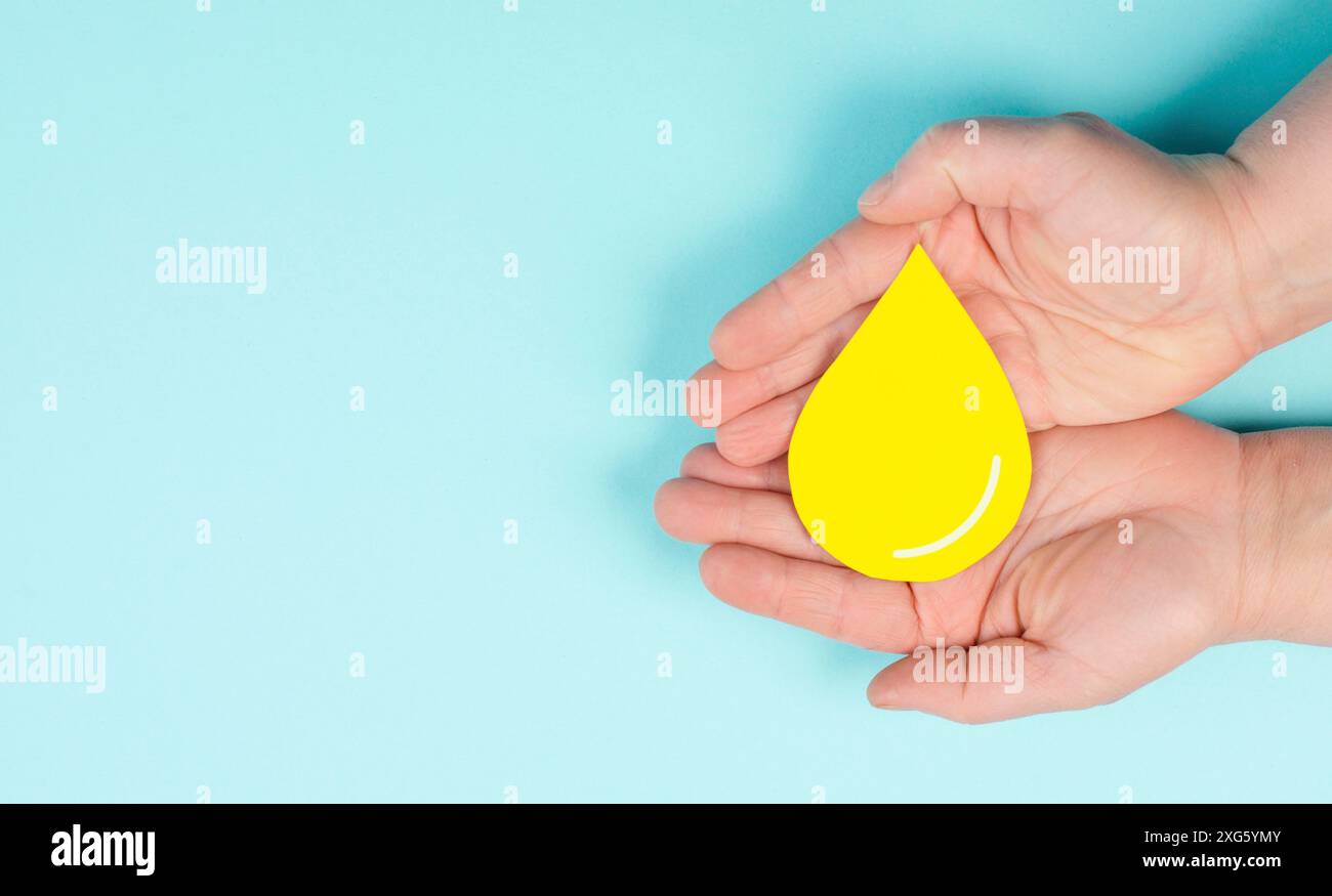 Holding a yellow drop, symbol for gas, petrol, diesel and oil, price ...