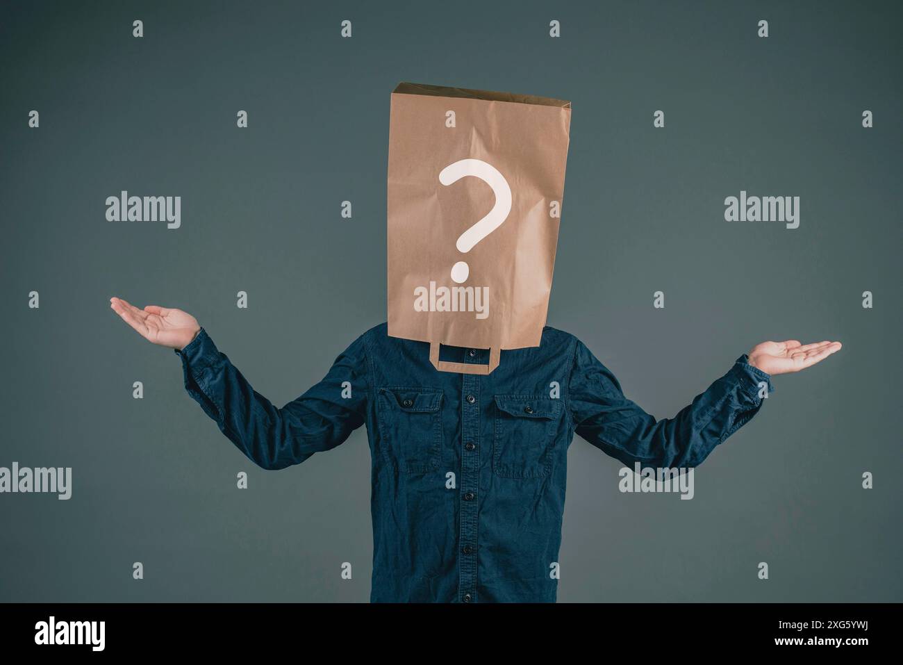 A young man has a paper bag on his head with a question mark, asking ...