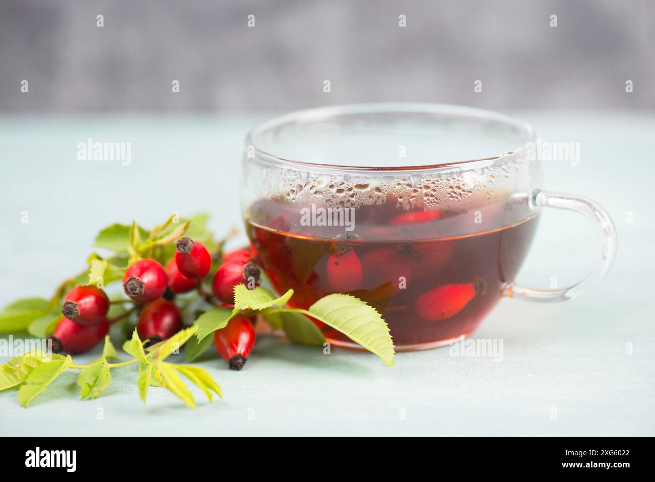 Hip rose tea with fresh fruits and leaves, hot drink Stock Photo - Alamy