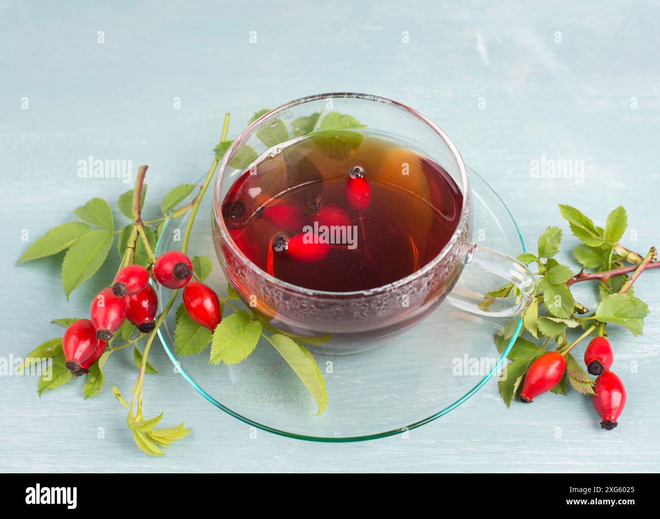 Hip rose tea with fresh fruits and leaves, hot drink Stock Photo - Alamy