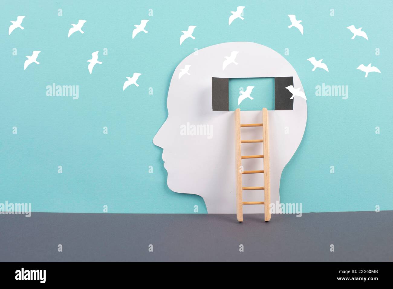 Silhouette of a man, window to the brain, birds flying, ladder of ...