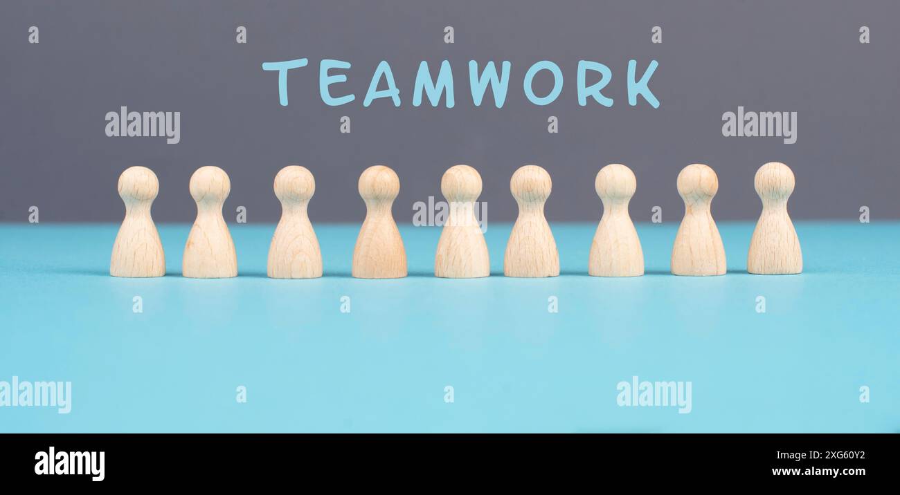 The word teamwork is standing over a group of people, working together ...