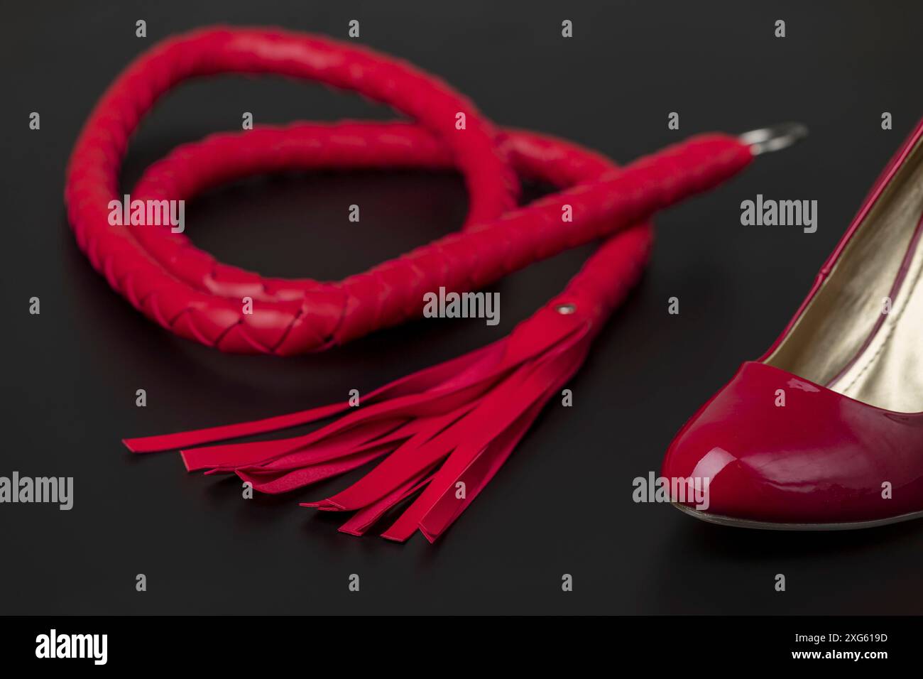 Red whip and a high heel Stock Photo - Alamy