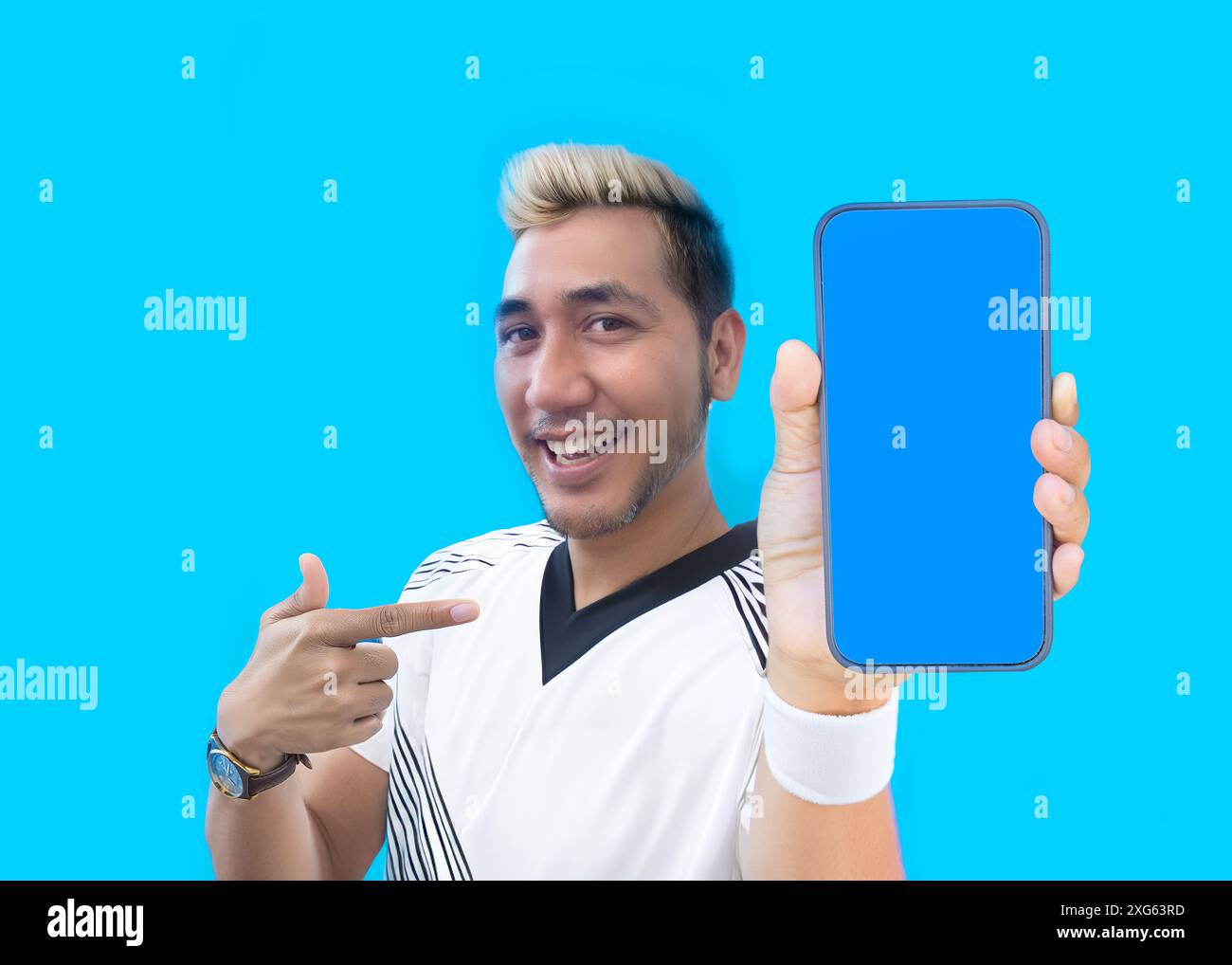 Asiam man wearing german Soccer jersey and point to mobile screen as ...