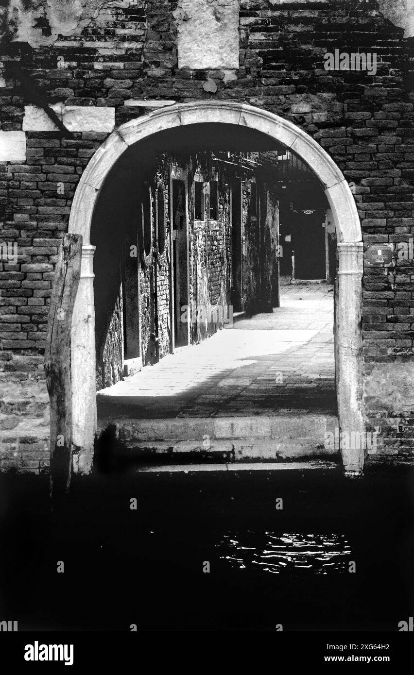 Residential archway architecture on water canal, Venice, Italy Stock ...
