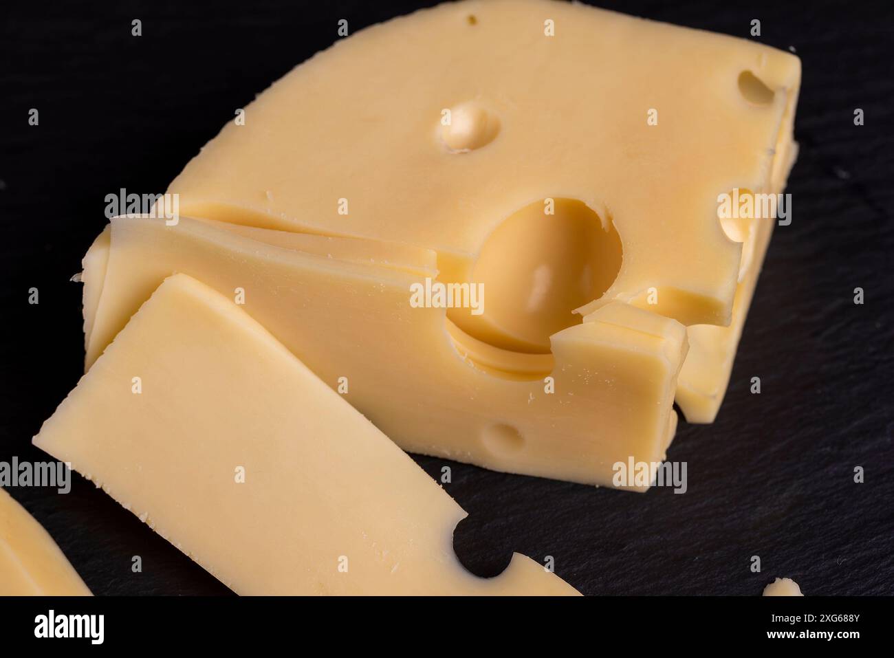 hard cheese with big holes close-up, high-quality cow's milk cheese ...