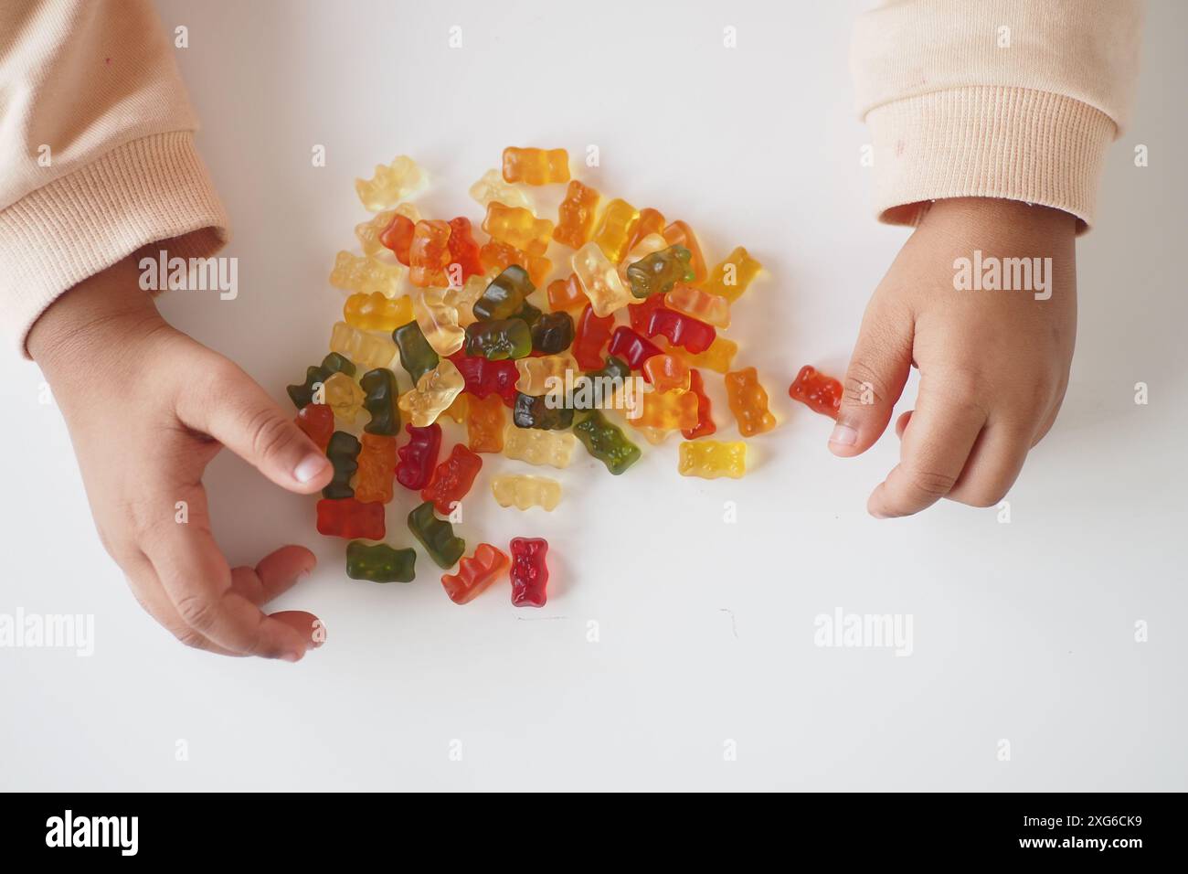 Child hand pick candy sweet hi-res stock photography and images - Alamy