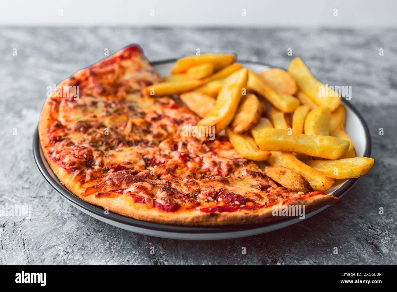 plate with half pizza half chips, concept of fast food or unhealthy ...