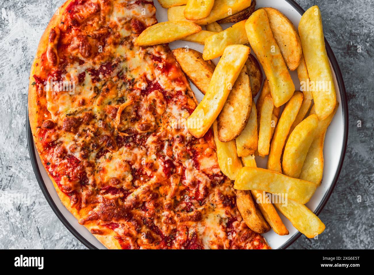 plate with half pizza half chips, concept of fast food or unhealthy ...