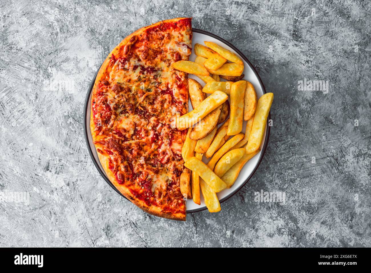 plate with half pizza half chips, concept of fast food or unhealthy ...