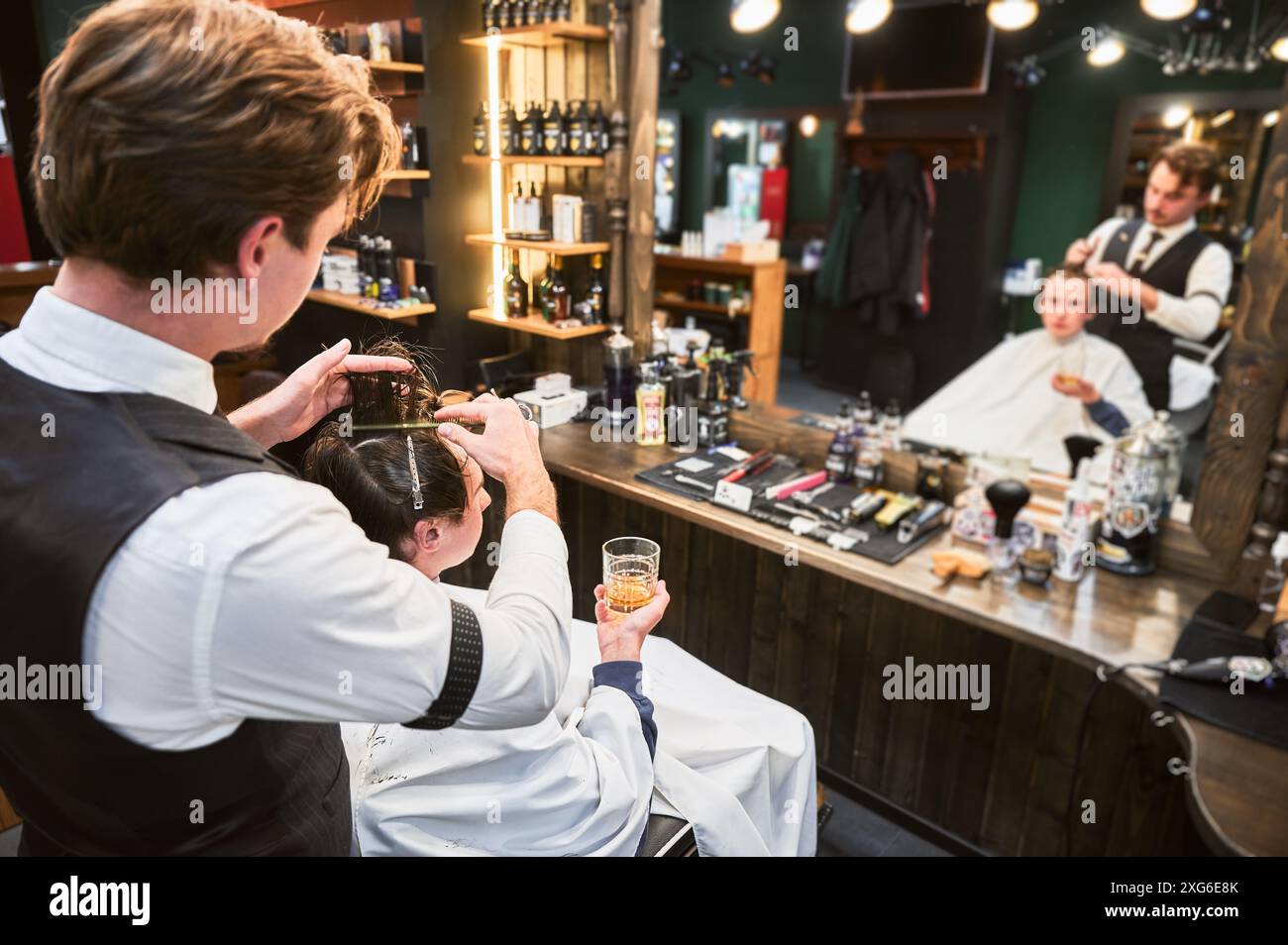 Cropped photo of handsome hairdresser in fancy outfit cutting wet hair ...