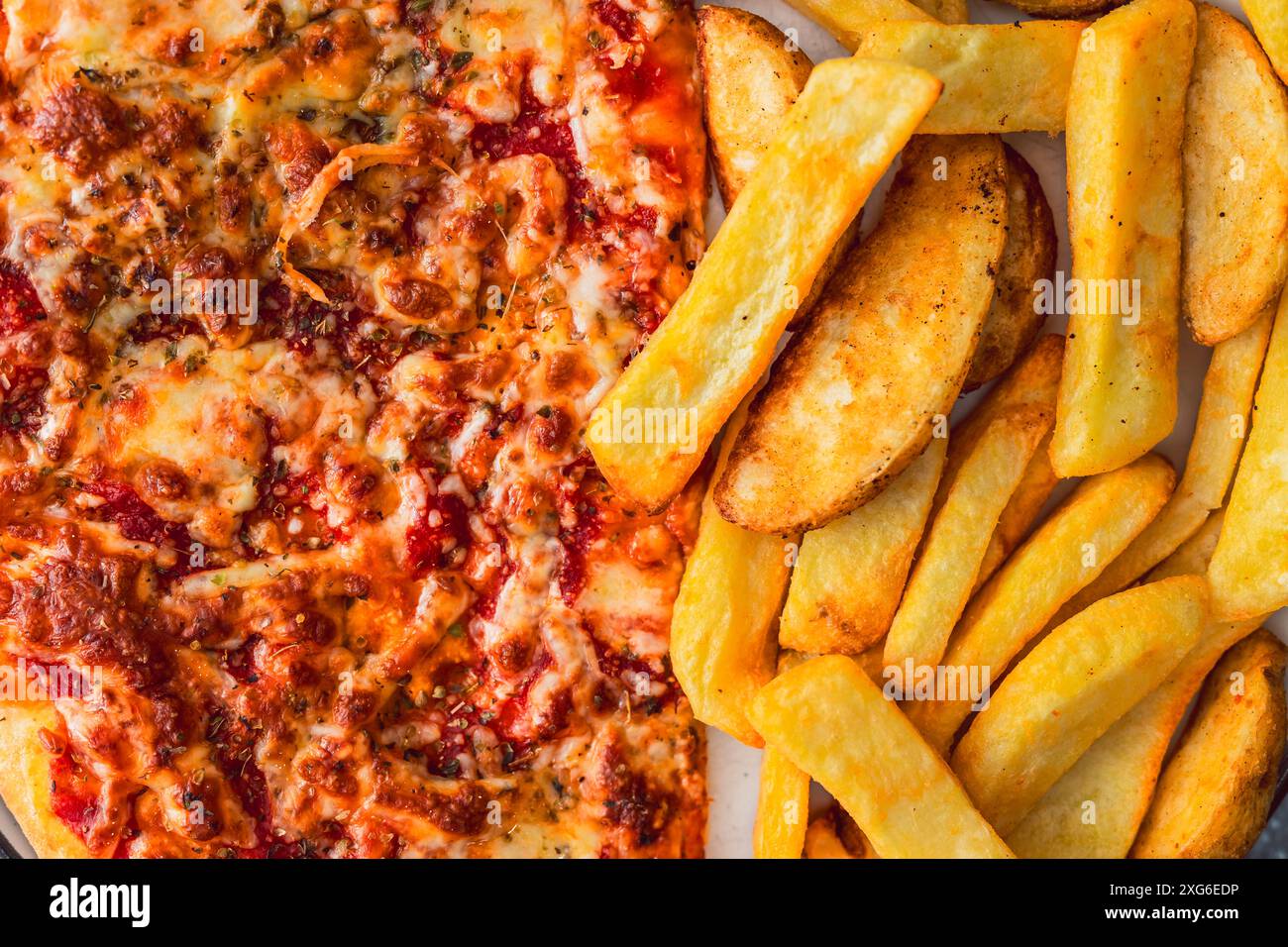 plate with half pizza half chips, concept of fast food or unhealthy ...