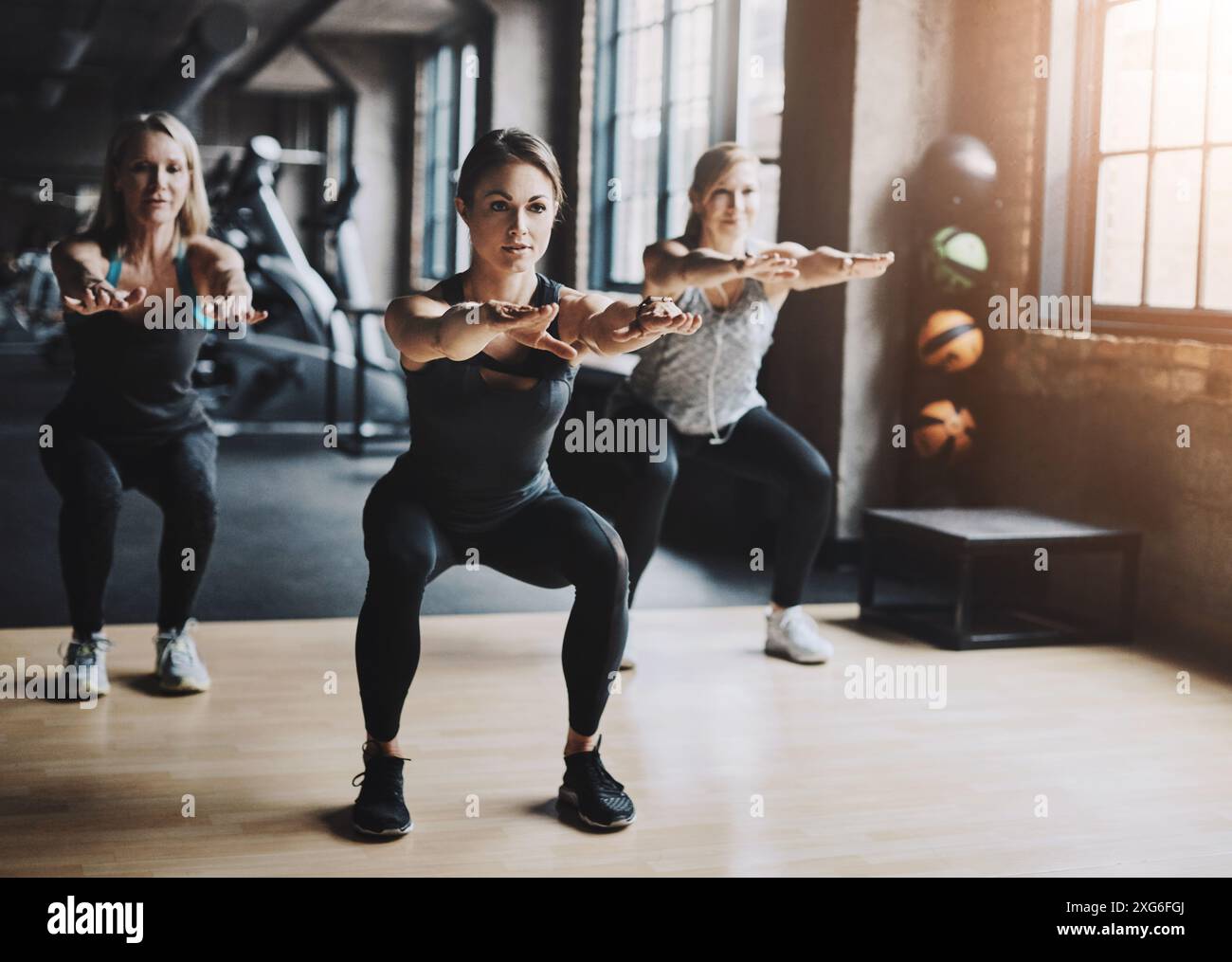 Fitness, class and people with squat in gym for healthy body, training ...