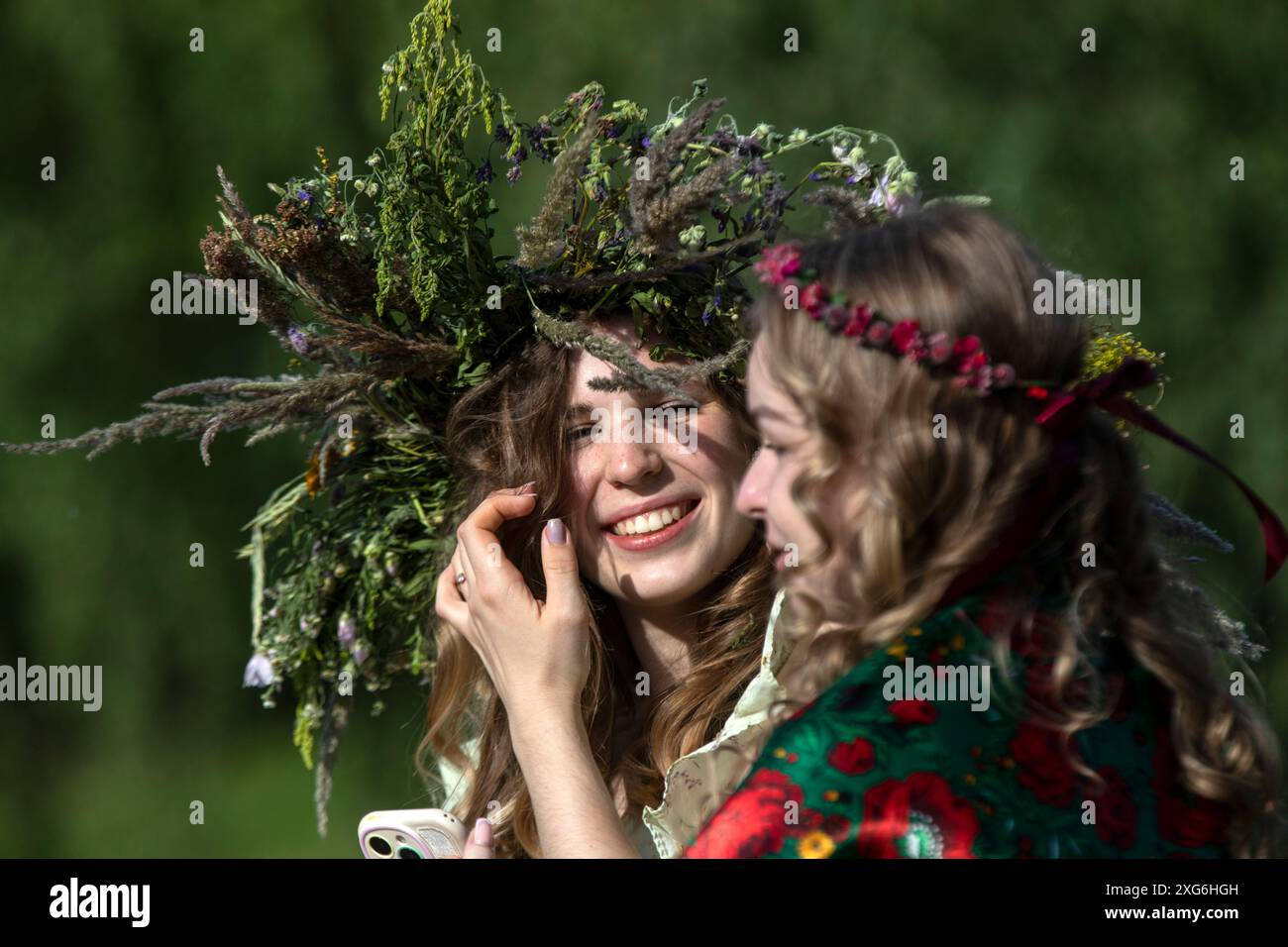 Moscow, Russia. 6th of July, 2024. Girls in wreaths of wildflowers are ...