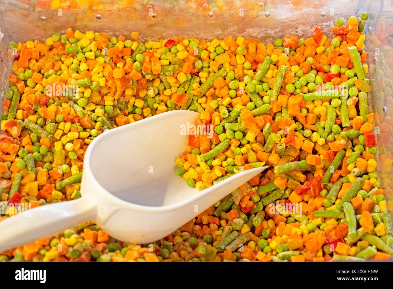 frozen vegetables weighed in a container in a supermarket. Healthy diet ...